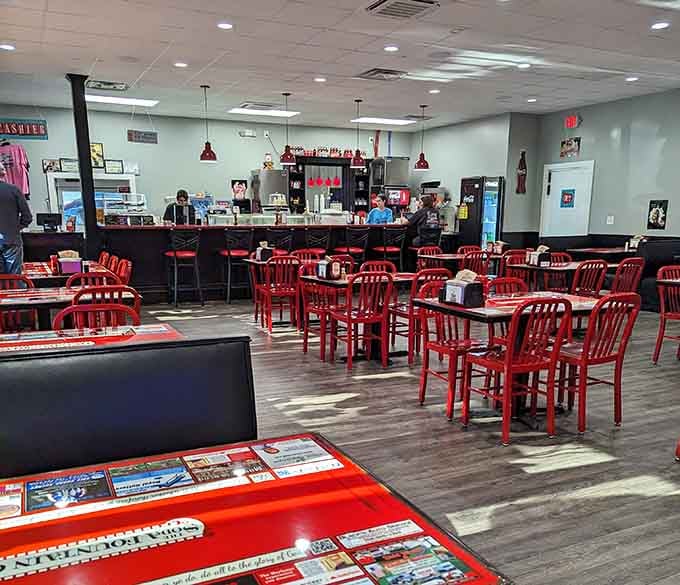 Rows of red chairs waiting to cradle happy diners in retro comfort while ice cream works its magic.
