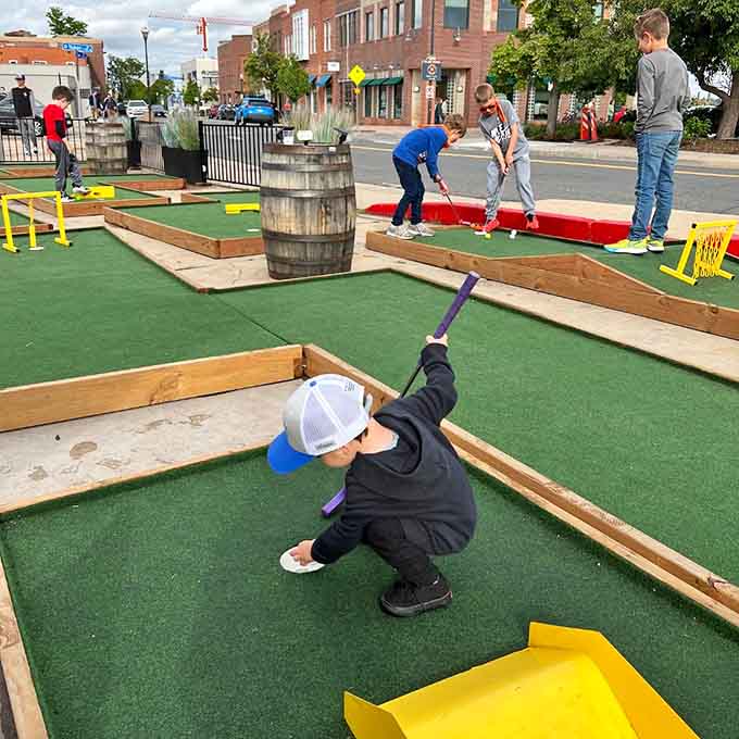 Kids conquering the mini-golf course while parents enjoy the patio – that's what we call a win-win situation.