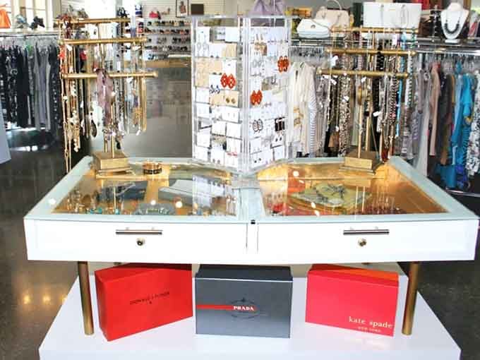 That glass jewelry case gleams with possibilities while designer shopping bags underneath hint at the treasures customers are already claiming as their own.