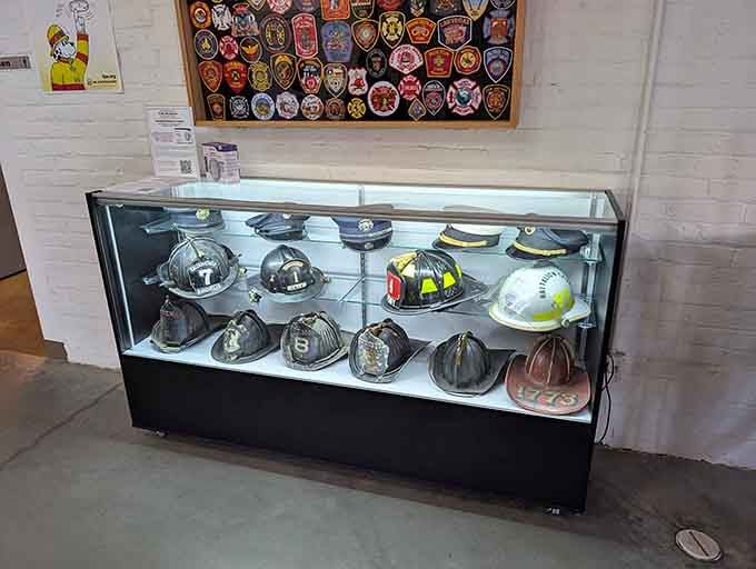 The helmet collection showcases decades of design evolution, each one protecting heroes who ran toward danger without hesitation.