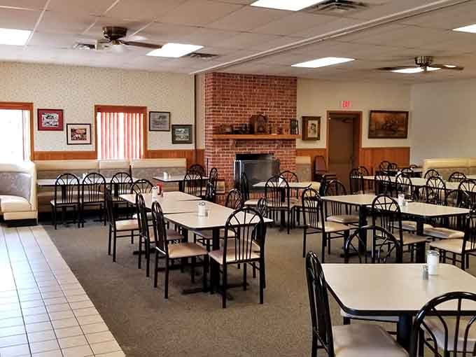 Spacious seating with a brick fireplace creates that welcoming atmosphere where lingering over breakfast feels absolutely encouraged and right.