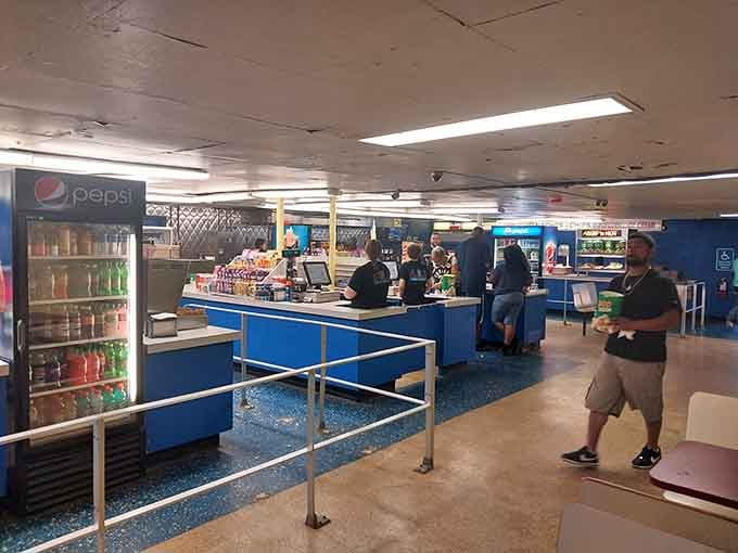 Inside the concession stand, that blue counter holds court over candy, popcorn, and every snack your dentist warns against.