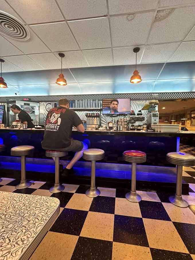 Those chrome counter stools with blue lighting underneath bring that authentic retro vibe straight from the Eisenhower era.