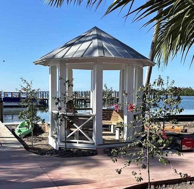 A charming gazebo sits waterside, perfect for contemplating life's mysteries or just watching boats drift lazily past the marina.
