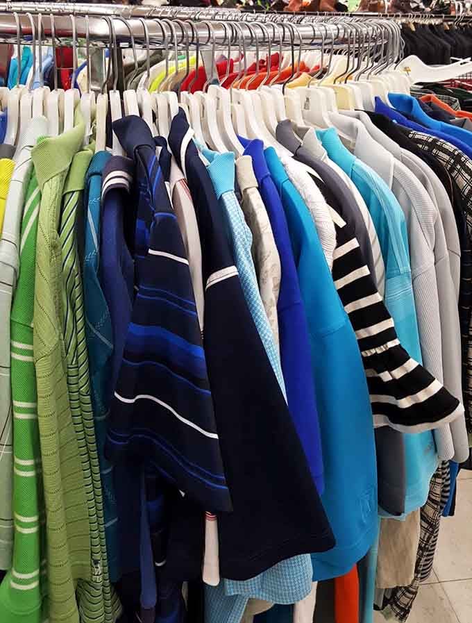 Men's shirts organized by color like a retail rainbow, minus the storm clouds of outrageous price tags.