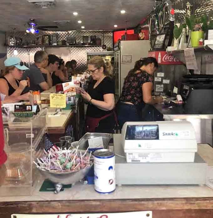 The counter buzzing with activity, where coffee flows freely and orders fly faster than a '57 Chevy.