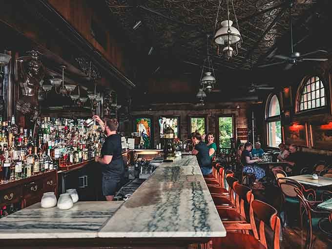 The long marble bar backed by bottles and tin ceilings creates the perfect setting for solving life's problems, one drink at a time.