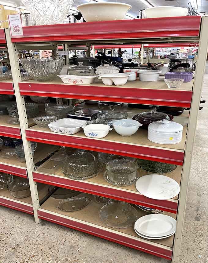 Kitchenware shelves stocked with everything from casserole dishes to serving platters, all priced to move quickly into homes.