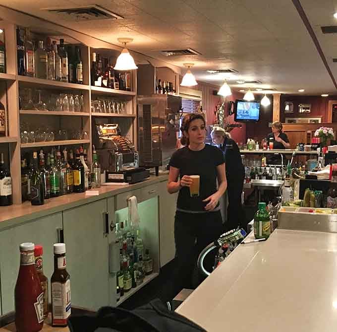 Friendly staff behind the bar ready to mix your cocktail and make your evening feel special and welcoming.