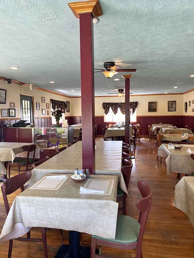 Burgundy columns and cream walls with family photos create an atmosphere that feels like dining in someone's very welcoming home instead.