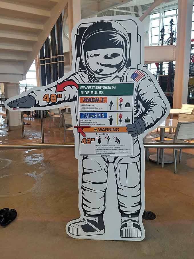 Height requirements displayed on an astronaut cutout, because even space travelers need to follow waterpark safety rules.