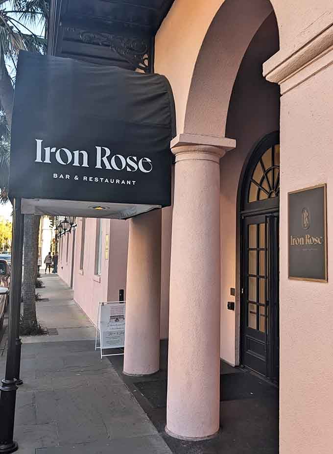 That pink building and elegant archway entrance signal you've found Iron Rose where sophisticated dining meets Charleston's historic charm perfectly.