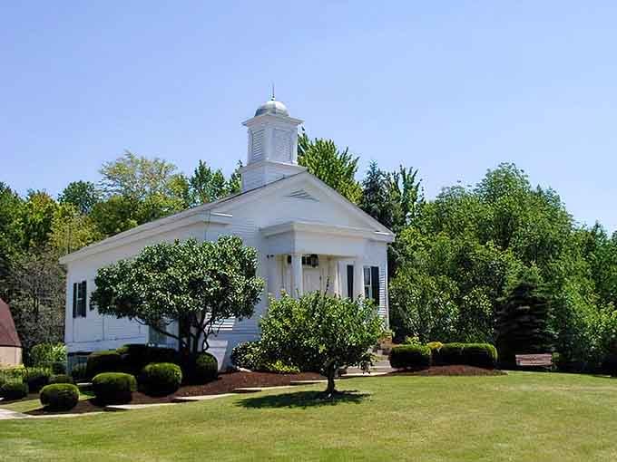 This pristine white chapel sits surrounded by manicured lawns, embodying the peaceful simplicity of small-town community values.