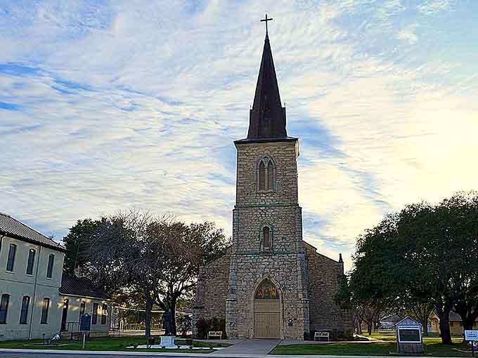 This stone church rises gracefully against the evening sky, its steeple pointing heavenward like a faithful compass.