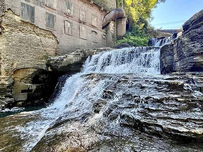 Layered rock formations frame this hidden waterfall, proving nature's architecture rivals anything humans could design.