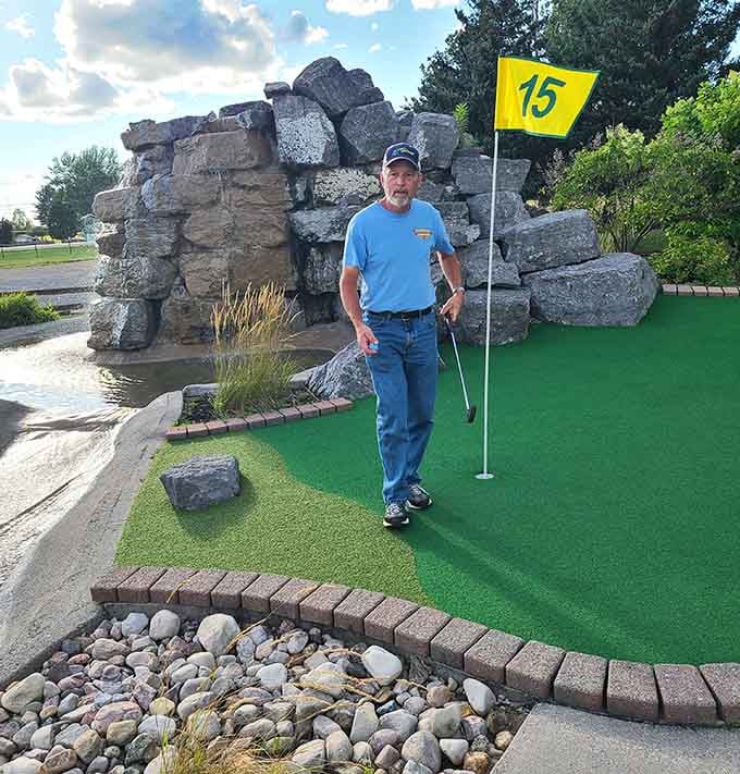 Someone's clearly been practicing their putting stance, though the bright yellow flag suggests this hole remains unconquered by most mortals.