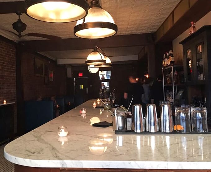 A marble bar top and pendant lighting create the perfect spot for cocktail contemplation and people watching.