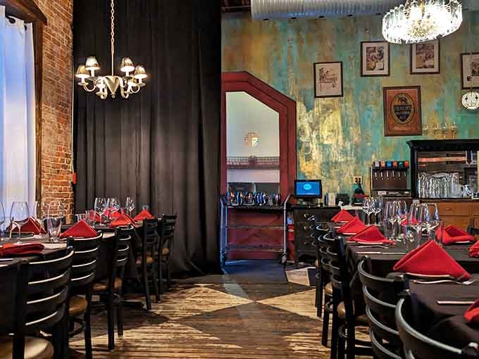 Red napkins and intimate lighting create the perfect setting for celebrating life's special moments over exceptional food.