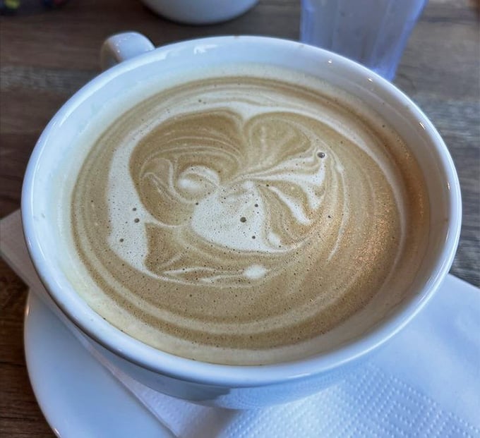 Coffee with latte art that's almost too pretty to drink. Almost, but not quite, because coffee.