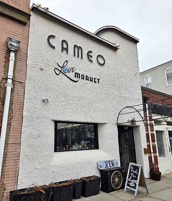 The Cameo Love Market storefront whispers vintage charm with weathered paint that proves some things get better with graceful aging.