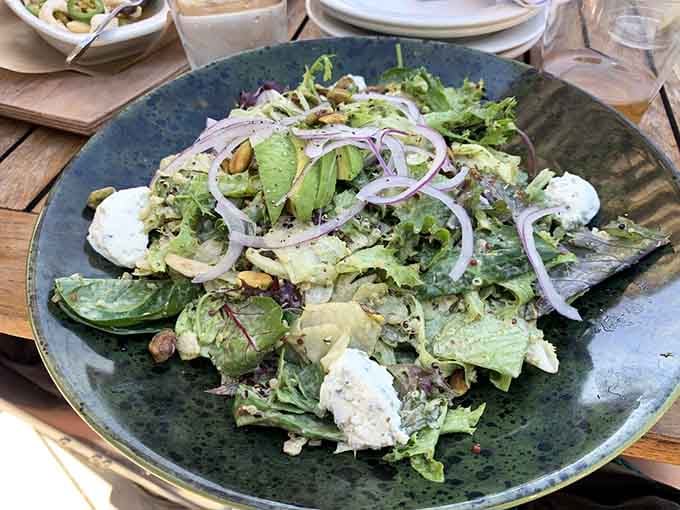 Fresh greens topped with creamy goat cheese and red onion ribbons remind us salads can actually be exciting.