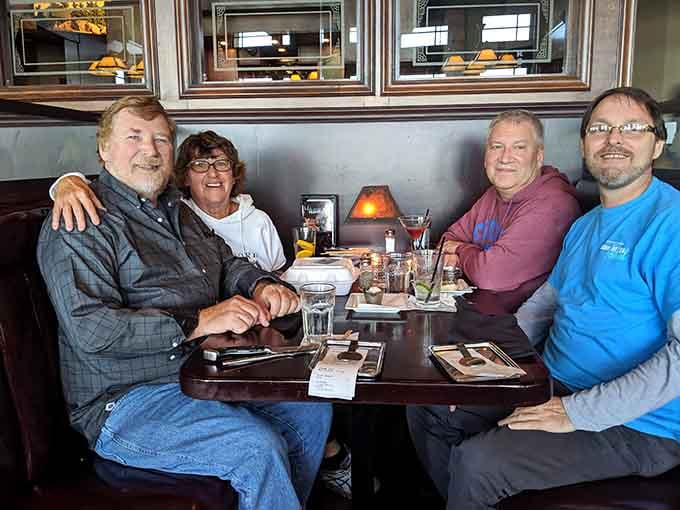 Four happy diners sharing a meal and probably debating which dish they're ordering next time they come back.