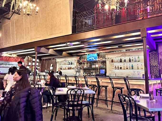 The sleek bar beckons with bottles lined up like soldiers, ready to craft your next favorite cocktail.