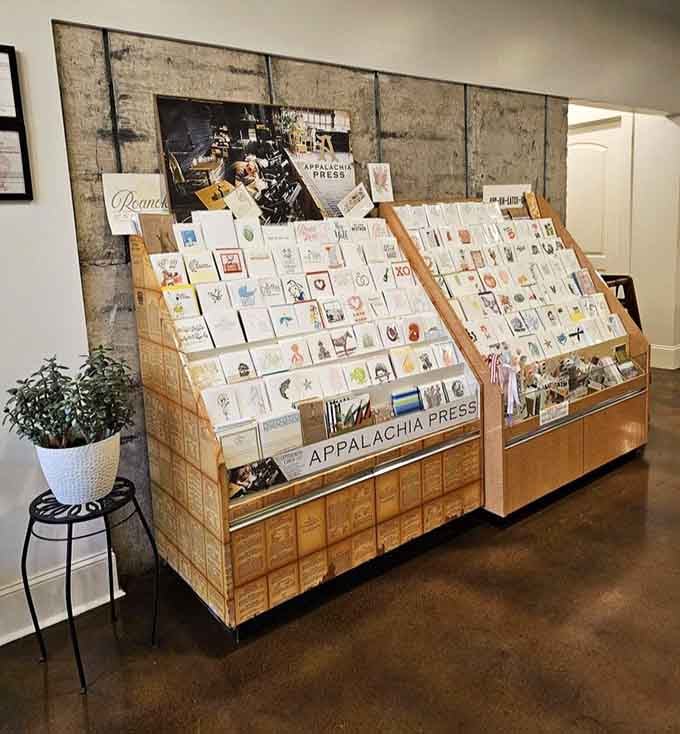 Locally printed greeting cards displayed on wooden racks add charm and support regional artists simultaneously, which feels wonderfully intentional.