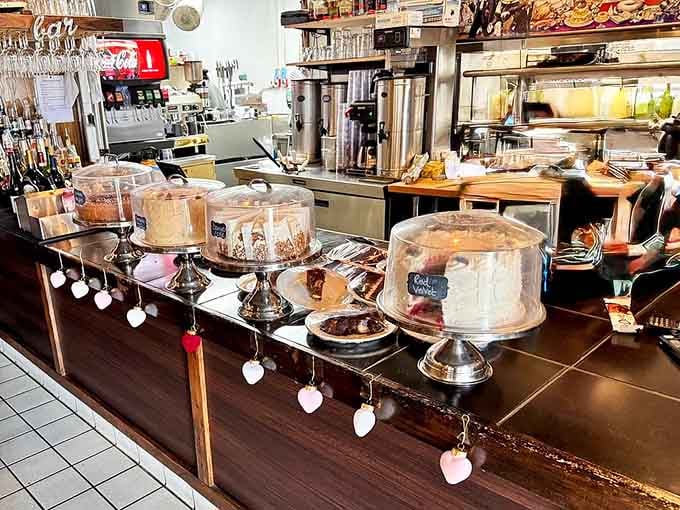 That dessert display case is basically a glass monument to temptation, daring you to save room for something sweet.