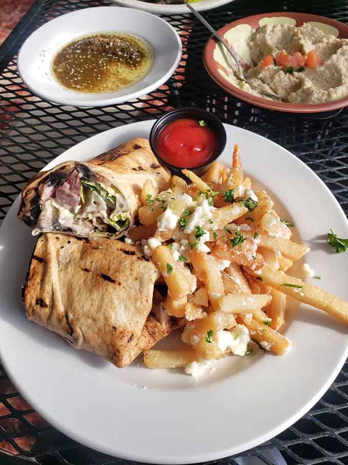 The portabella mushroom wrap proves vegetarian options can be just as exciting, served with garlic-topped fries and dipping sauces.