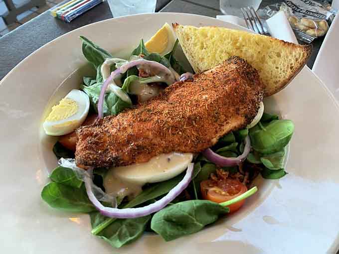 Fresh spinach salad topped with blackened salmon, providing a lighter option that still celebrates the Chesapeake's bounty beautifully.