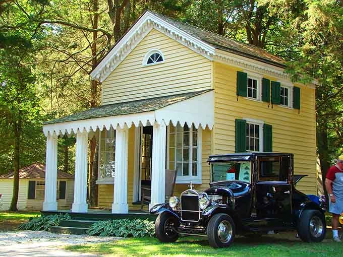 That vintage automobile parked beside the yellow cottage looks ready to drive straight into a Gatsby party.