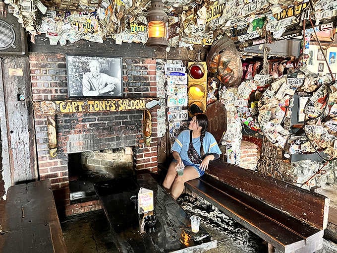 Sitting beneath layers of history and currency, this visitor becomes part of the bar's ongoing story collection.