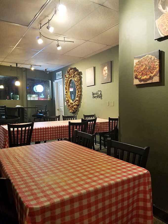 That ornate mirror and intimate table settings create a dining room that feels both elegant and wonderfully unpretentious.