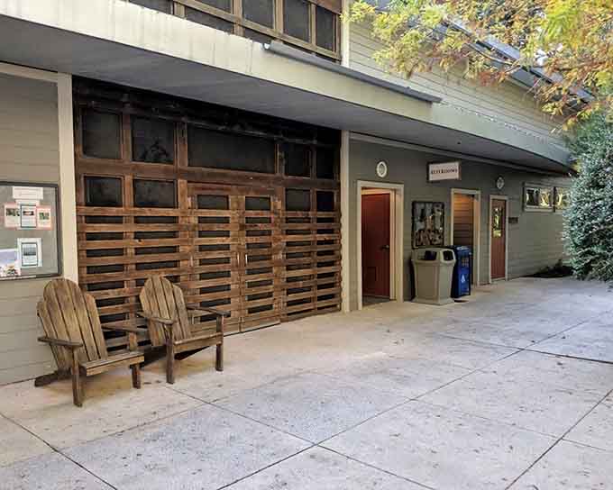 Even nature preserves need restrooms, and these Adirondack chairs suggest someone understands the importance of comfortable waiting areas for companions.