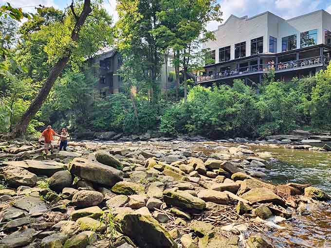 Rocky riverbed below the falls invites exploration, though your shoes might have different opinions about that plan.