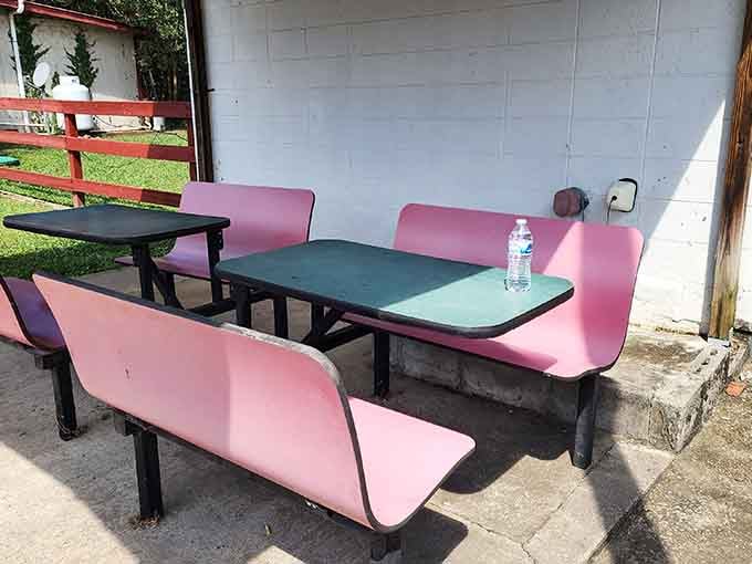 Pink picnic tables outside offering al fresco dining for those perfect Alabama evenings when the weather cooperates beautifully.