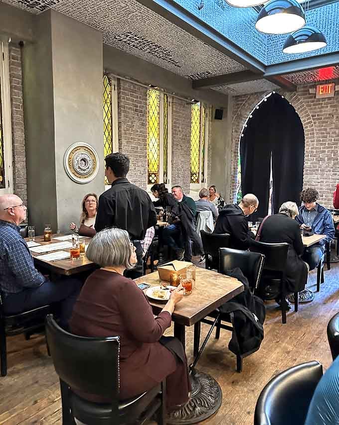 Happy diners fill the space with conversation and laughter, creating the kind of warm energy that makes restaurants feel alive.