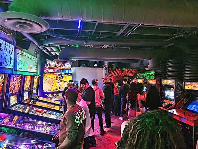 A crowd gathered around pinball machines, proving that some forms of entertainment never go out of style.