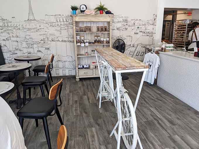 Parisian street scene mural, bicycle table, cozy seating: it's like someone built your fantasy breakfast spot.