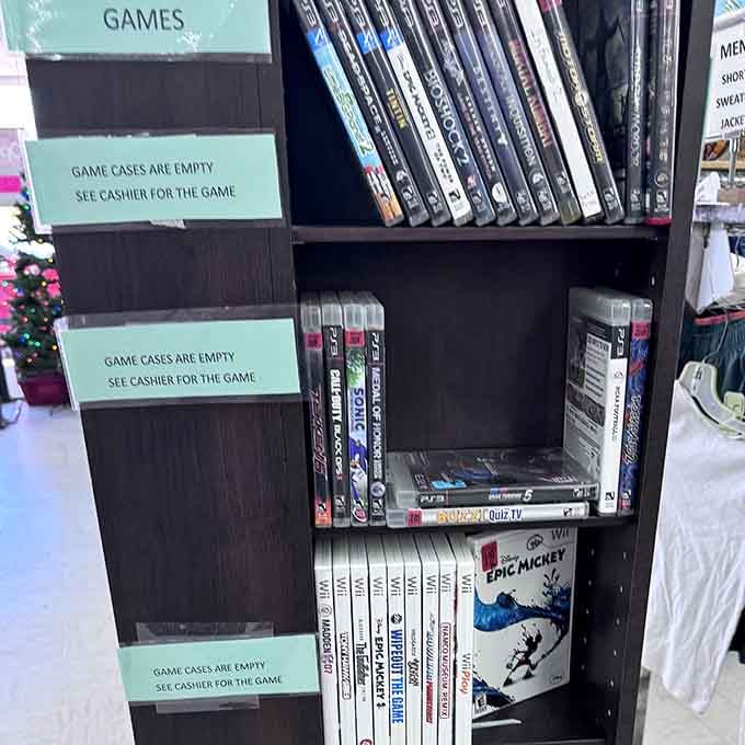 Video games await behind the counter, offering entertainment from multiple console generations at thrift store prices.