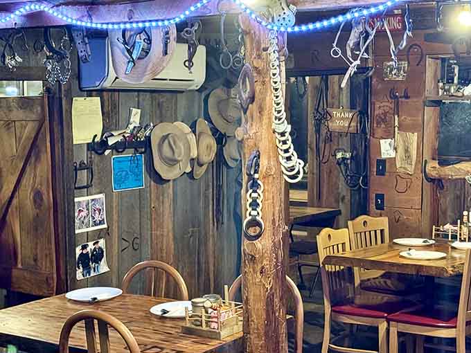 Horseshoes, vintage tools, and Western memorabilia transform every wall into a museum of authentic ranching history and heritage.