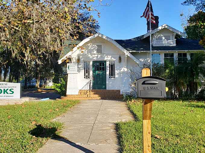 That classic white schoolhouse with turquoise door stands ready to share stories when books were entertainment, not decorations.