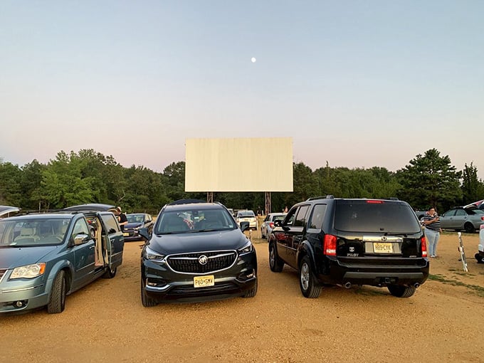 As twilight settles in, the parking lot transforms into a community of movie lovers in their mobile living rooms.
