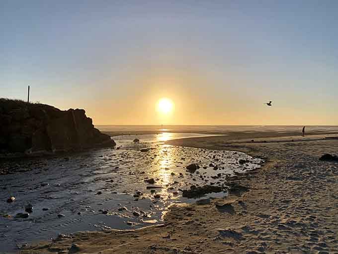 Sunset at the nearby beach paints the sky in golden hues, proving that Devil's Lake gives you two natural wonders for one.