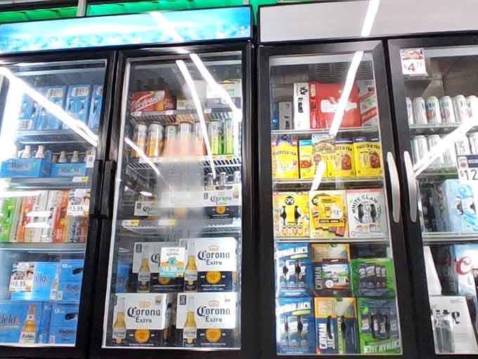 Cold beverages waiting in glass-front coolers, because shopping this much requires proper hydration and maybe a treat.