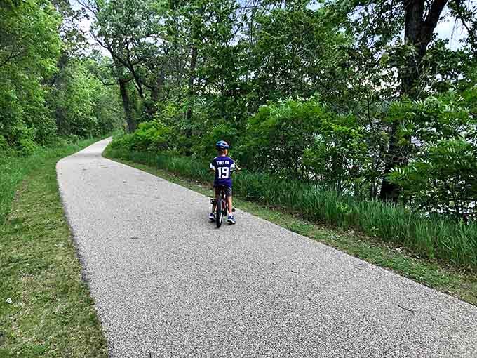 Young cyclists discover that paved trails make adventure accessible, helmets make parents happy, and freedom feels amazing.