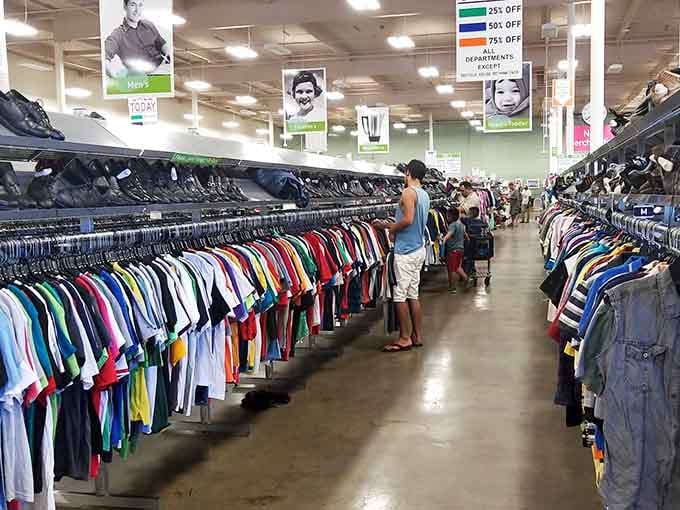 Shoppers doing the thrift store shuffle, that slow methodical browse perfected by bargain hunters everywhere since forever.