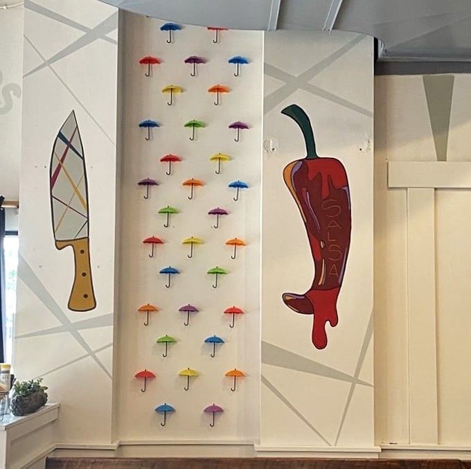 Whimsical wall art featuring colorful umbrellas and chili peppers adds personality without trying too hard to be Instagram-worthy.