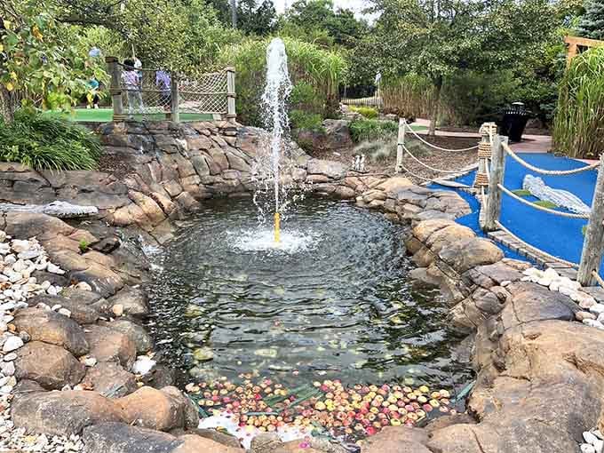 The fountain pond collects wayward balls like a magnet, teaching valuable lessons about aim and humility.